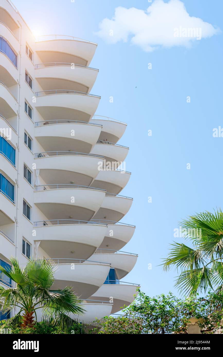 Sunlit side of a residential building with balconies. Fragment of a ...