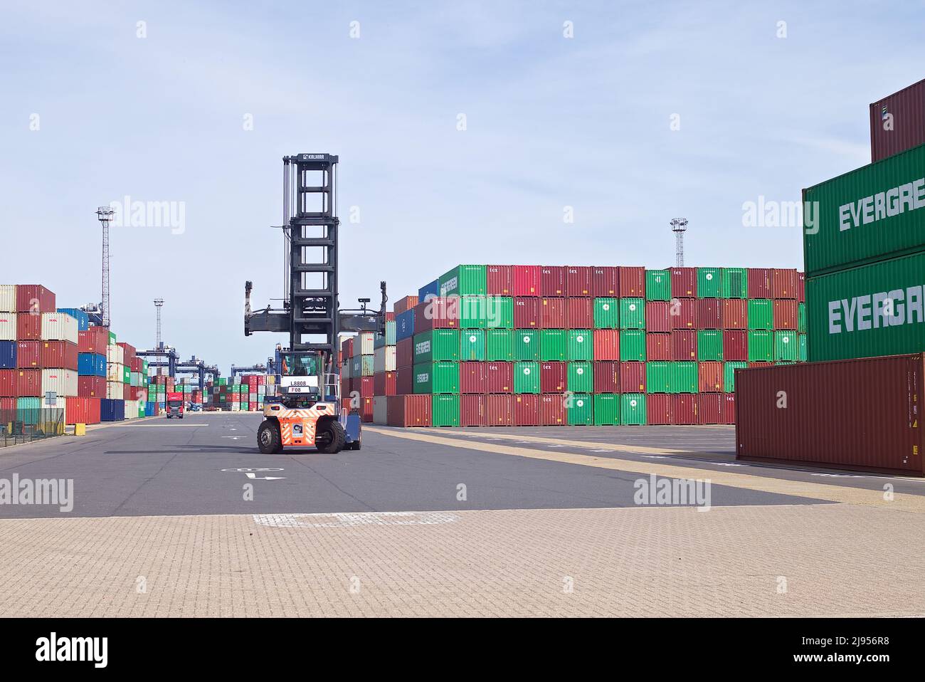 Container handler moving/loading containers in dockside container yard ...