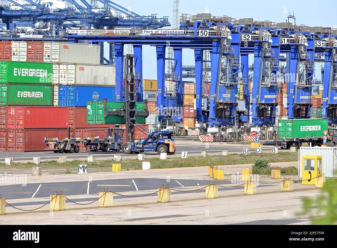 Container handler moving/loading containers in dockside container yard ...