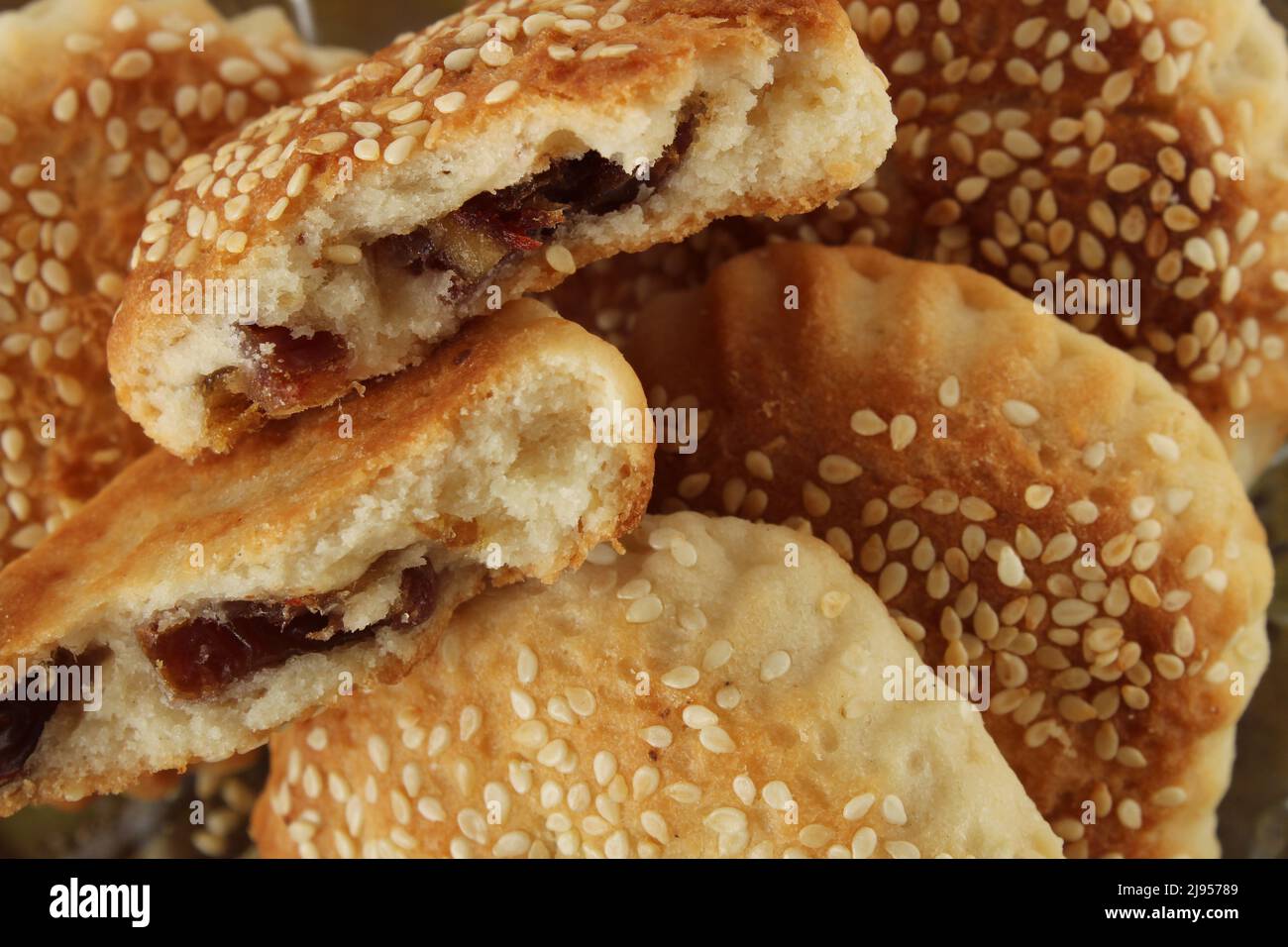 Date filled or stuffed pastry with sesame, close up on pastry with ...