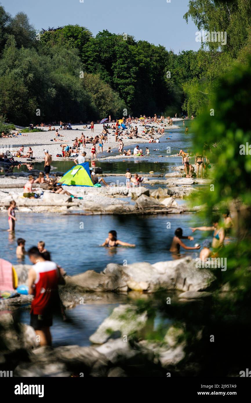 Munich, Germany. 20th May, 2022. Numerous people swim in the Isar at ...
