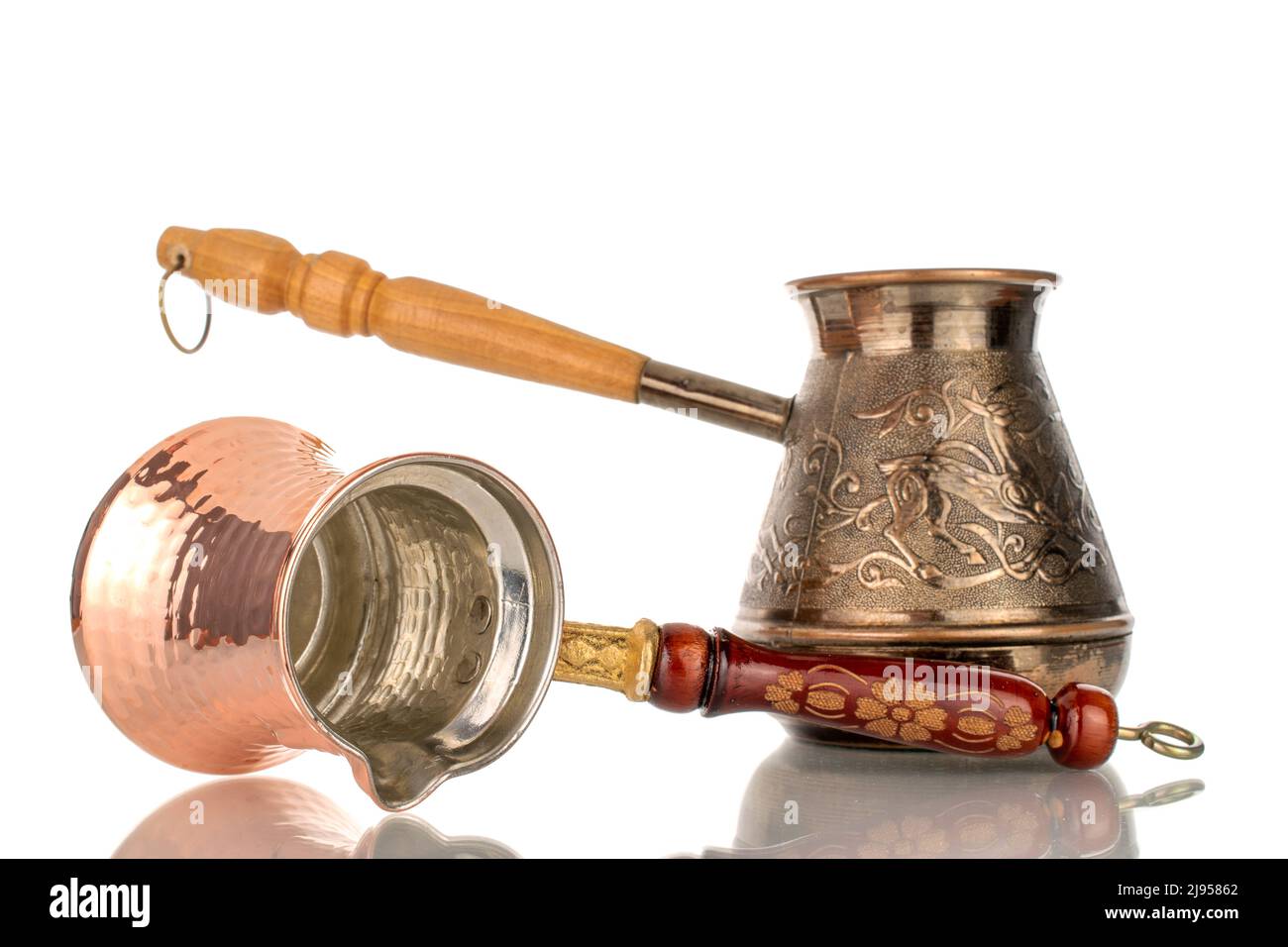 Two Turkish Cezve copper coffee pots with wooden handle, close-up ...