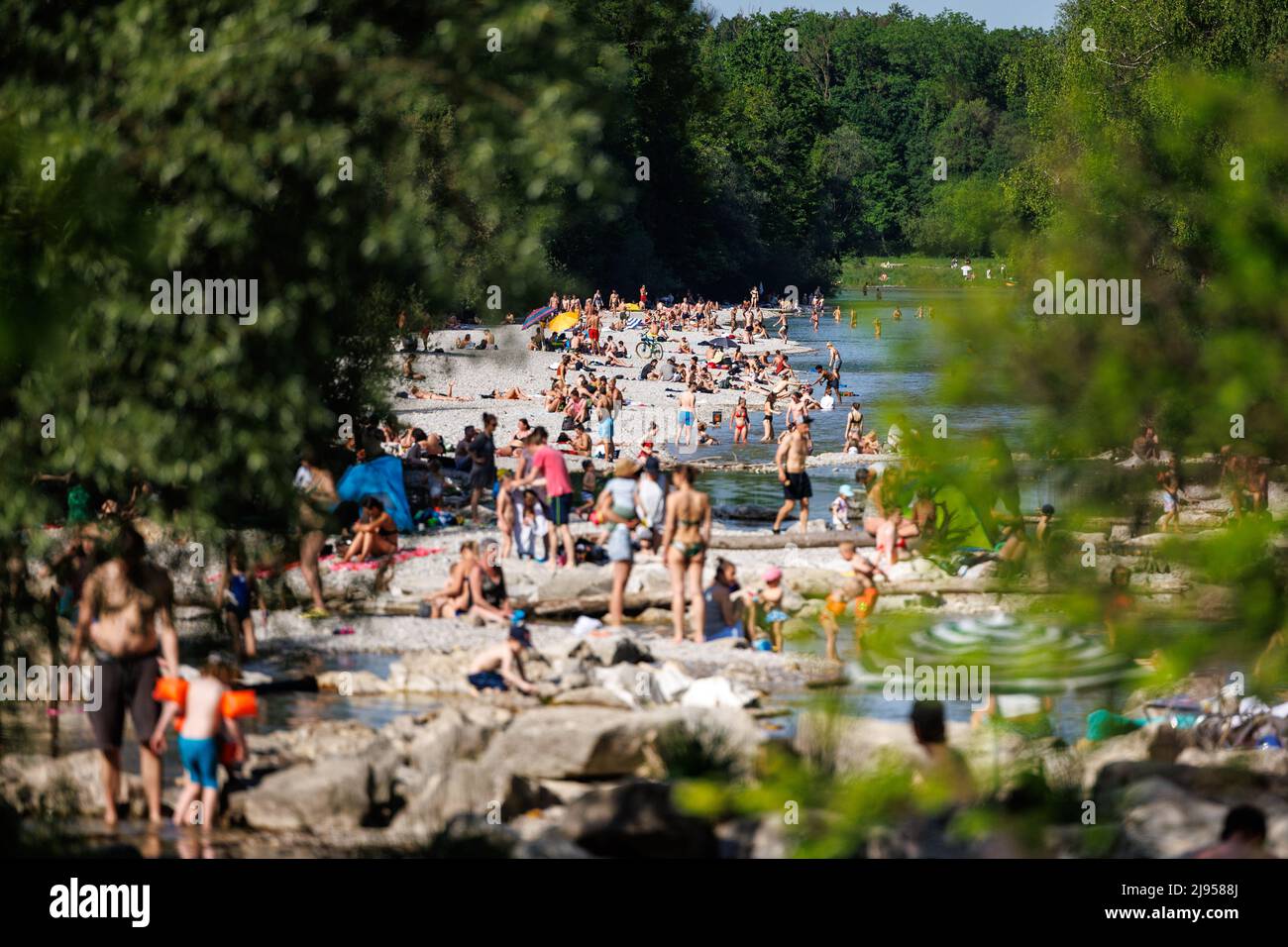 Munich, Germany. 20th May, 2022. Numerous people swim in the Isar at ...