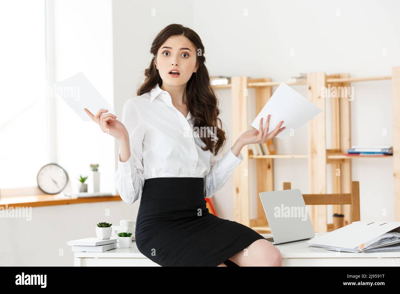 Shocked young business woman surprised by reading unexpected news in ...