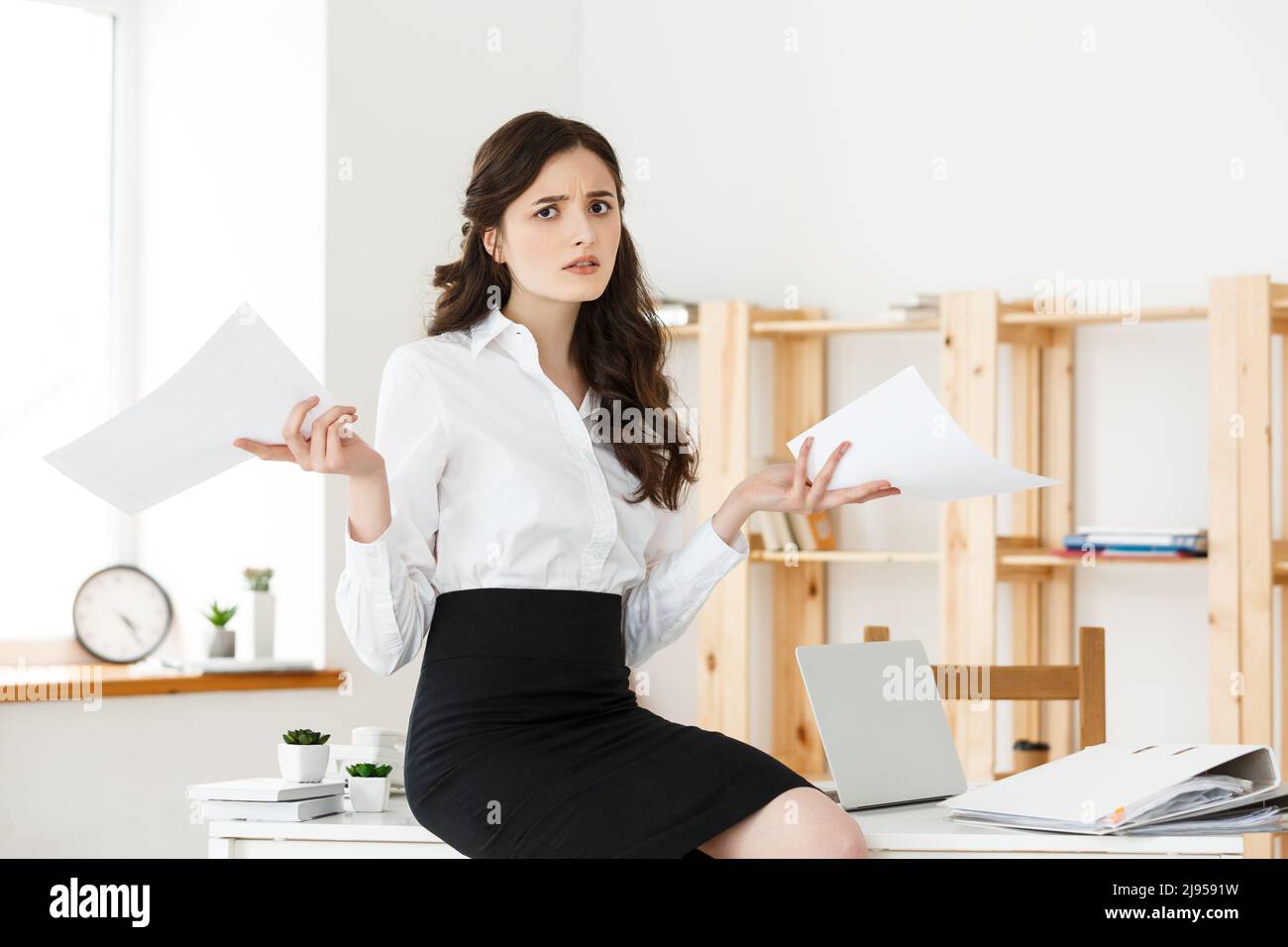 Shocked young business woman surprised by reading unexpected news in ...