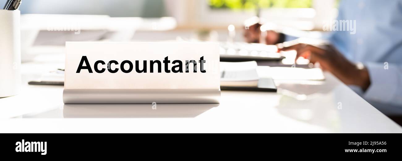 Accountant Name Plate On The Desk With The Businessman Analyzing The ...