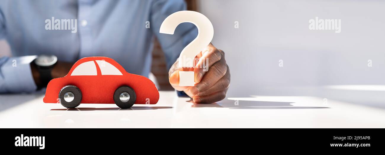 Person Hand Holding Question Mark Next To Car Model Stock Photo - Alamy