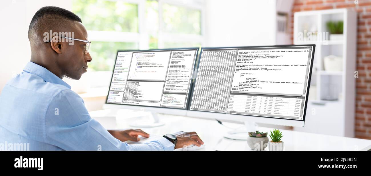 African American Coder Using Computer At Desk. Web Developer Stock ...
