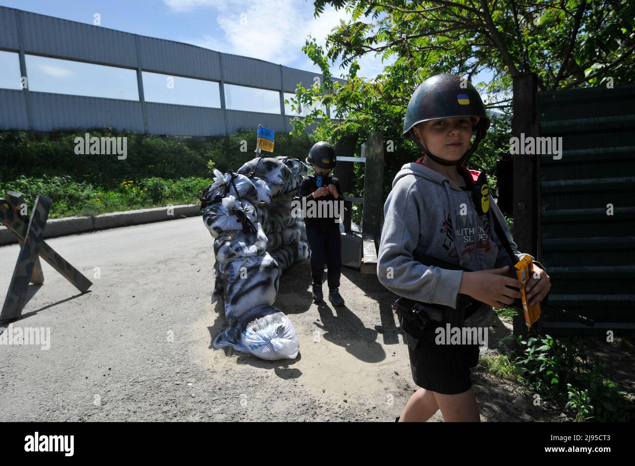 Stoyanka, Ukraine. 19th May, 2022. Ukrainian children play territorial ...