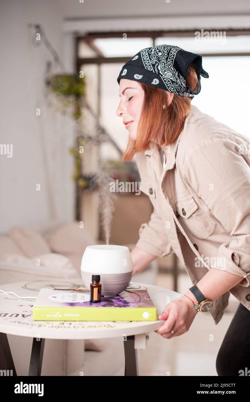 woman breathing and inhaling aroma from a doterra vaporizer Stock Photo ...