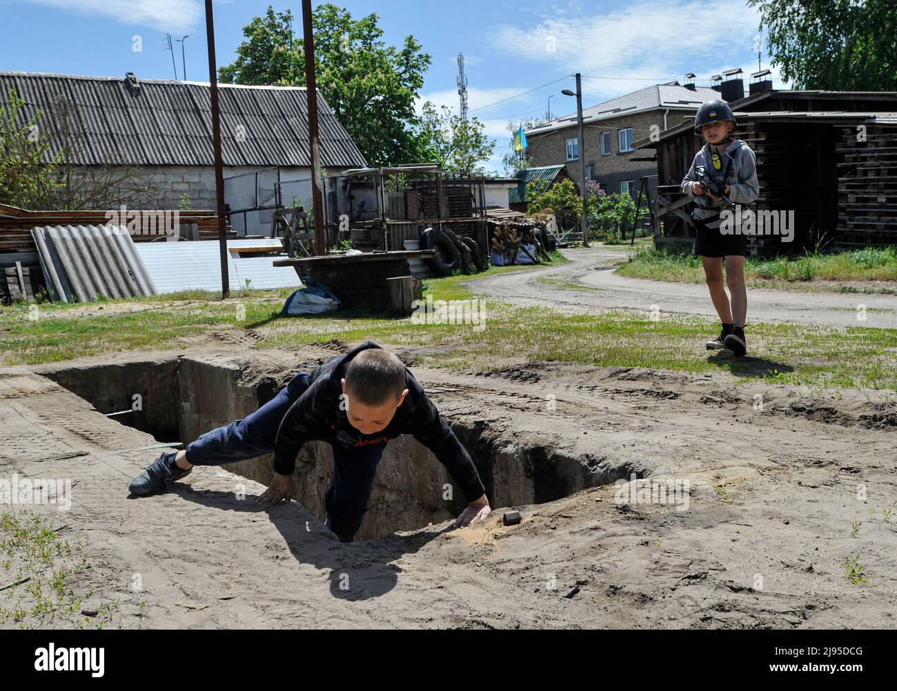 Stoyanka, Ukraine. 19th May, 2022. Ukrainian children play territorial ...
