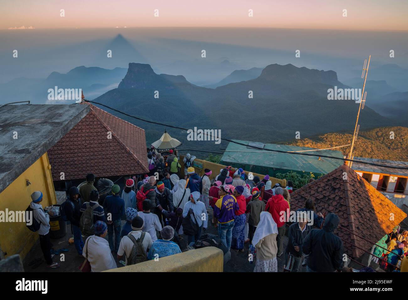 ADAM'S PEAK, SRI LANKA - MARCH 20, 2015: Pilgrims greet the dawn in a ...