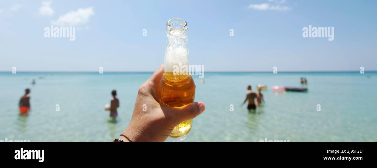 Horizontal banner or header with male hand holding a bottle of beer ...