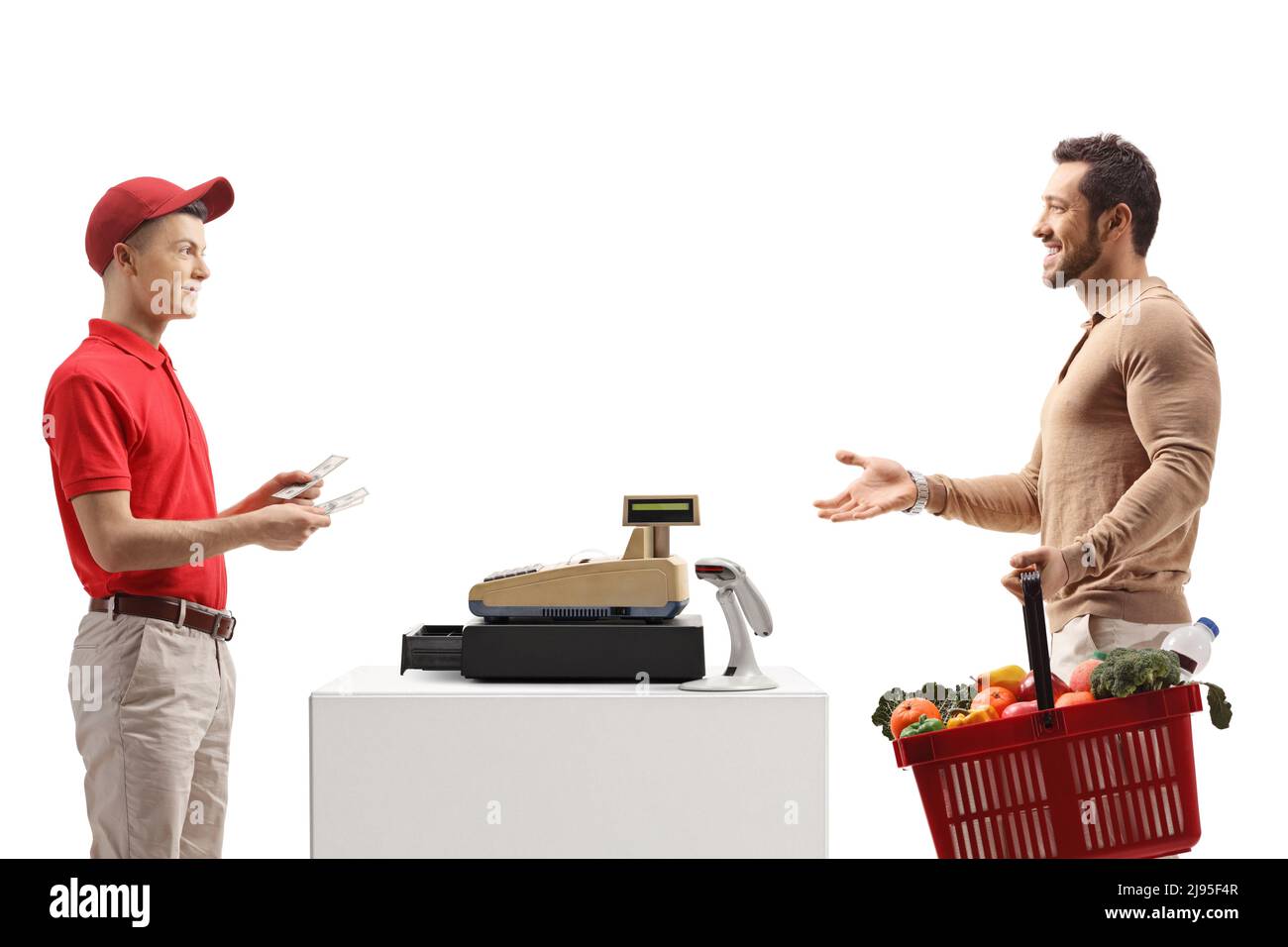 Male customer with a shopping basket paying at a cash register isolated ...