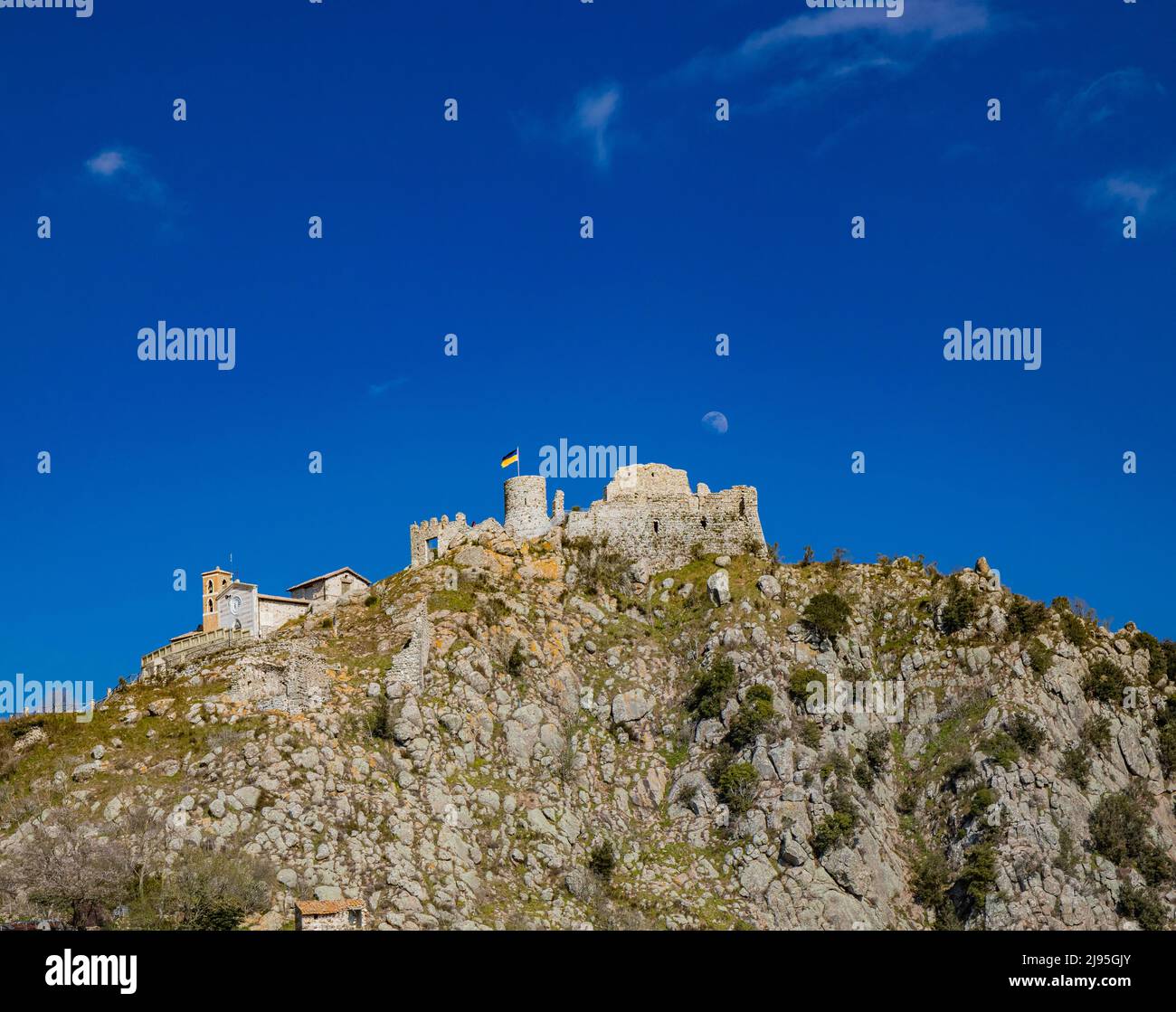 The small village of Tolfa, in Lazio. Remains of the ancient walls of ...