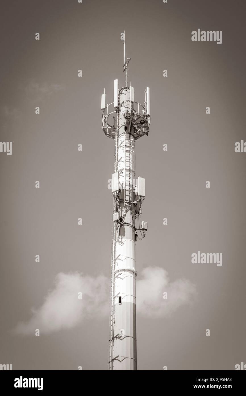 Old black and white picture Red white 5G tower with blue sky background ...
