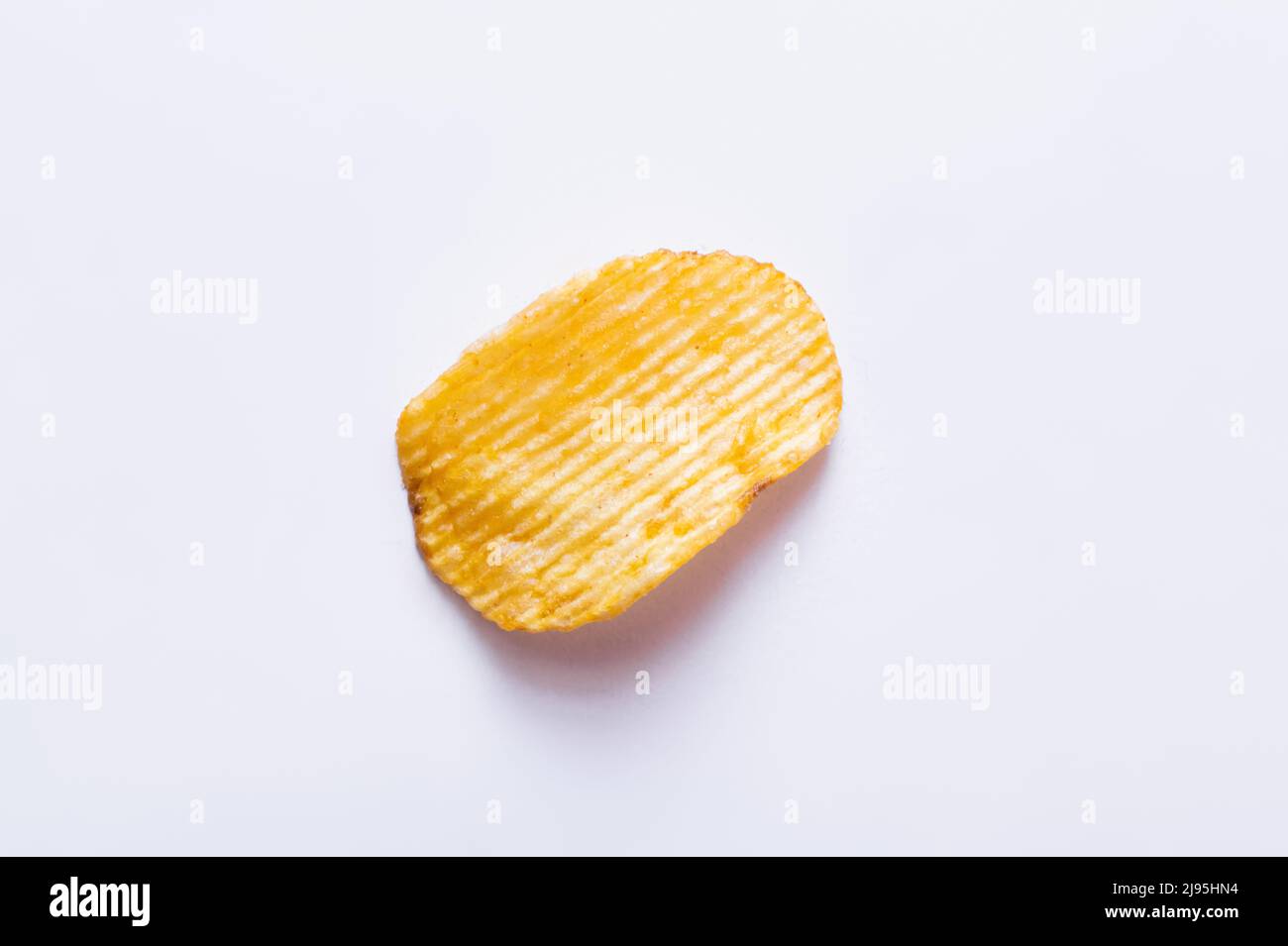 top view of single wavy and salty potato chip on white Stock Photo - Alamy