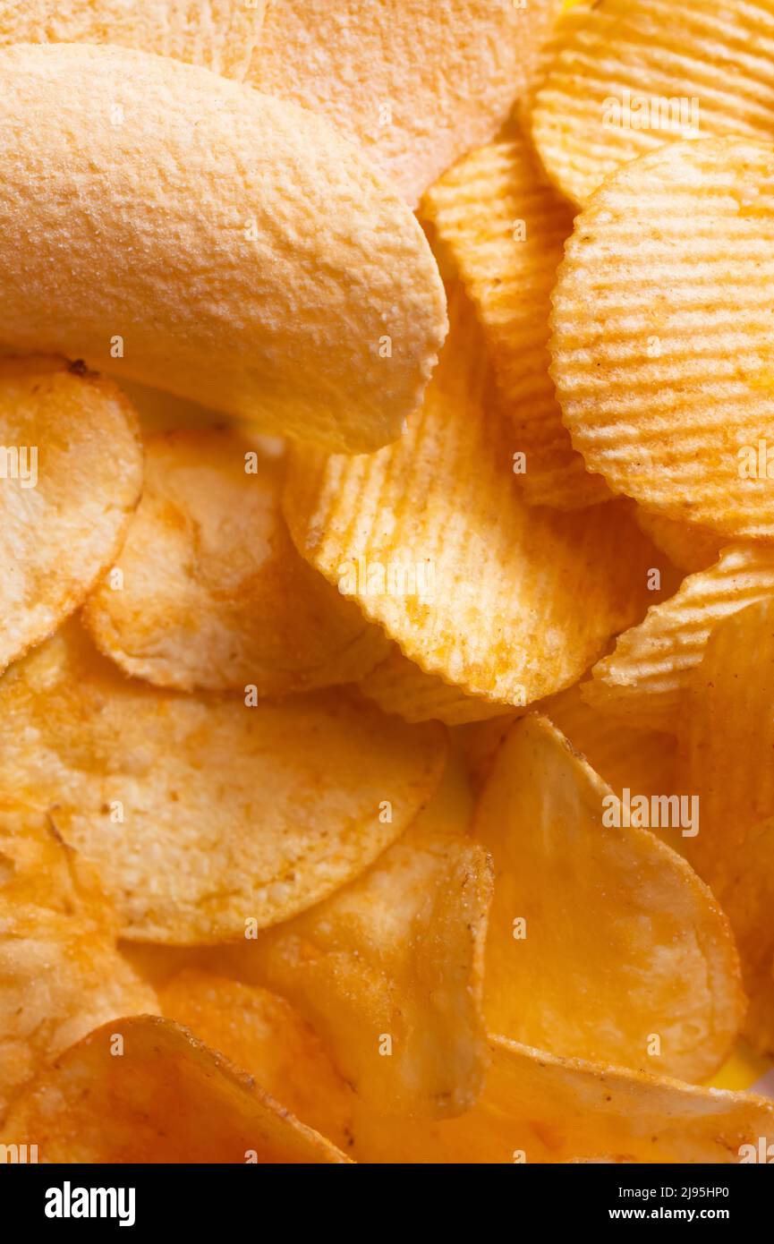 bunch of different delicious and salty potato chips, top view Stock ...