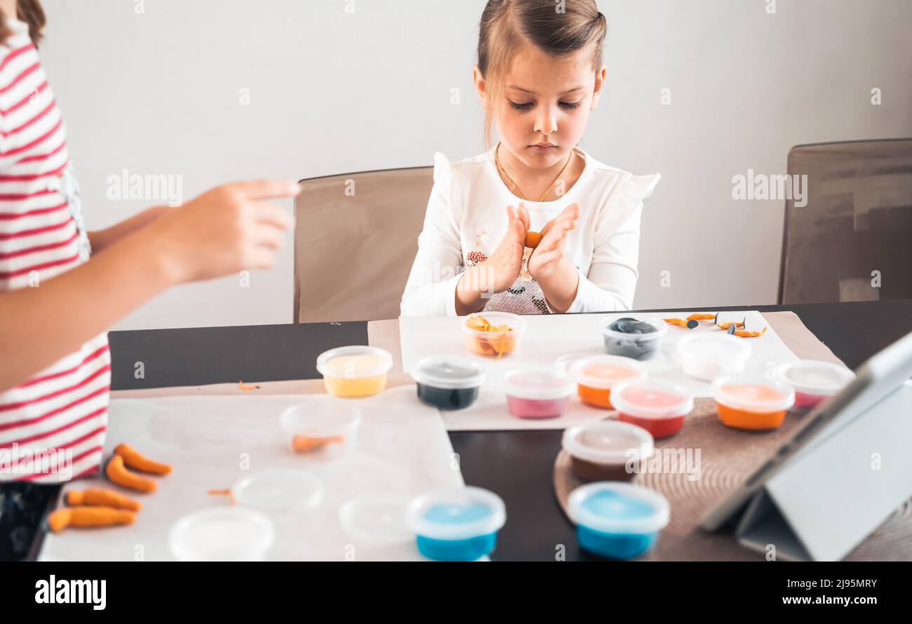 Little girls sculpt figurines crafts from air plasticine, modeling ...