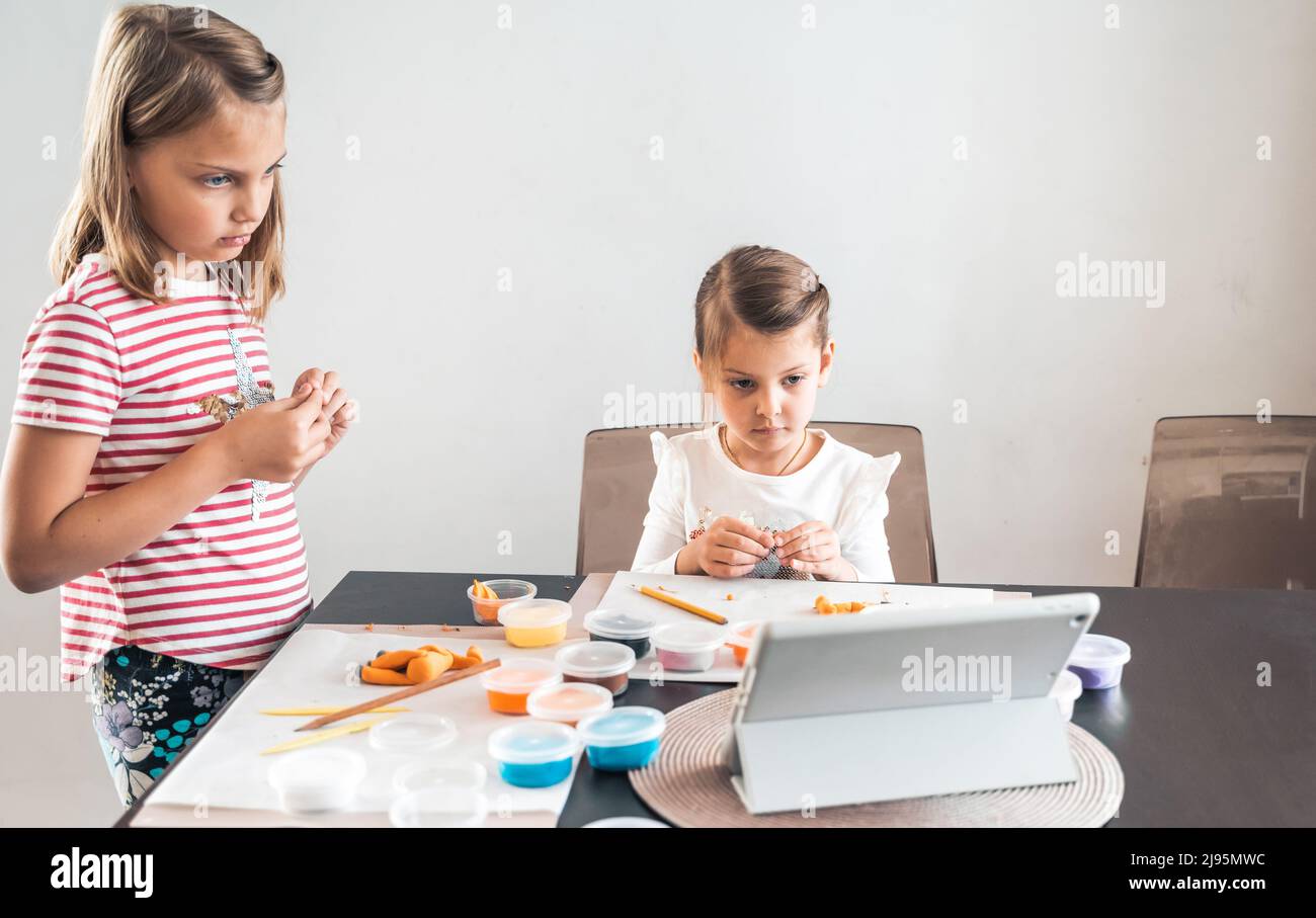 Little girls sculpt figurines crafts from air plasticine, modeling ...