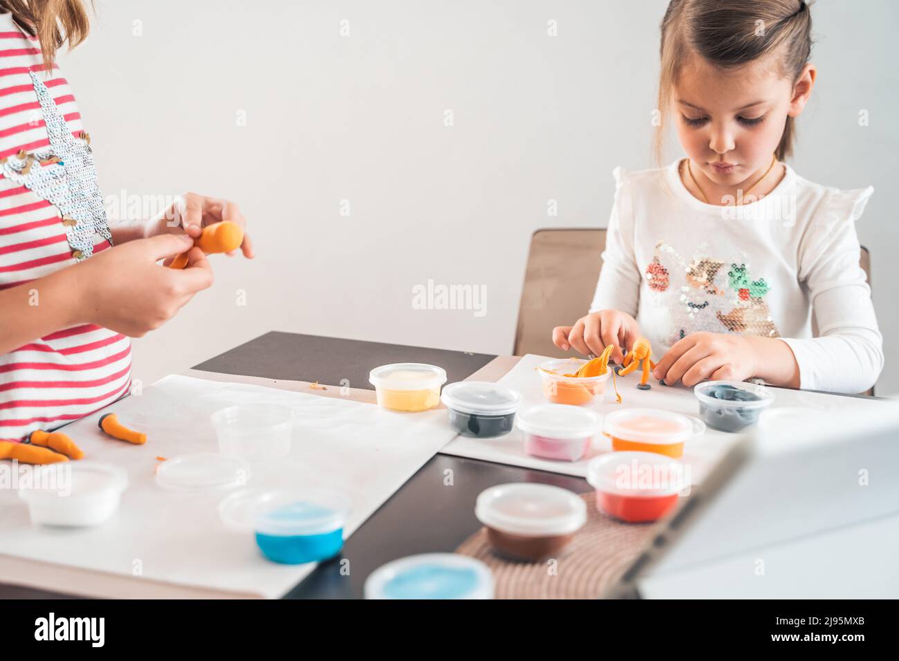 Little girls sculpt figurines crafts from air plasticine, modeling ...