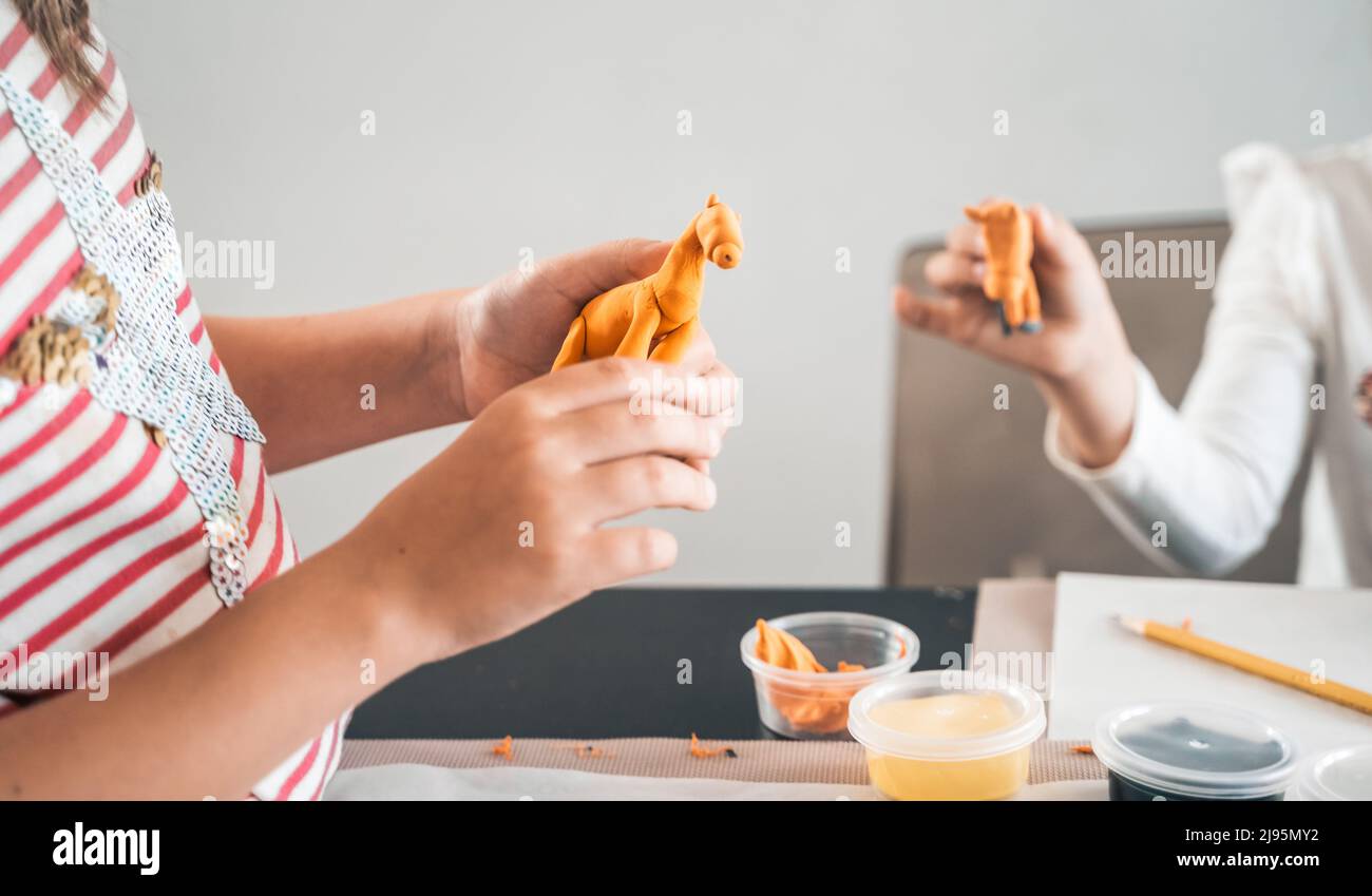 Little girls sculpt figurines crafts from air plasticine, modeling ...