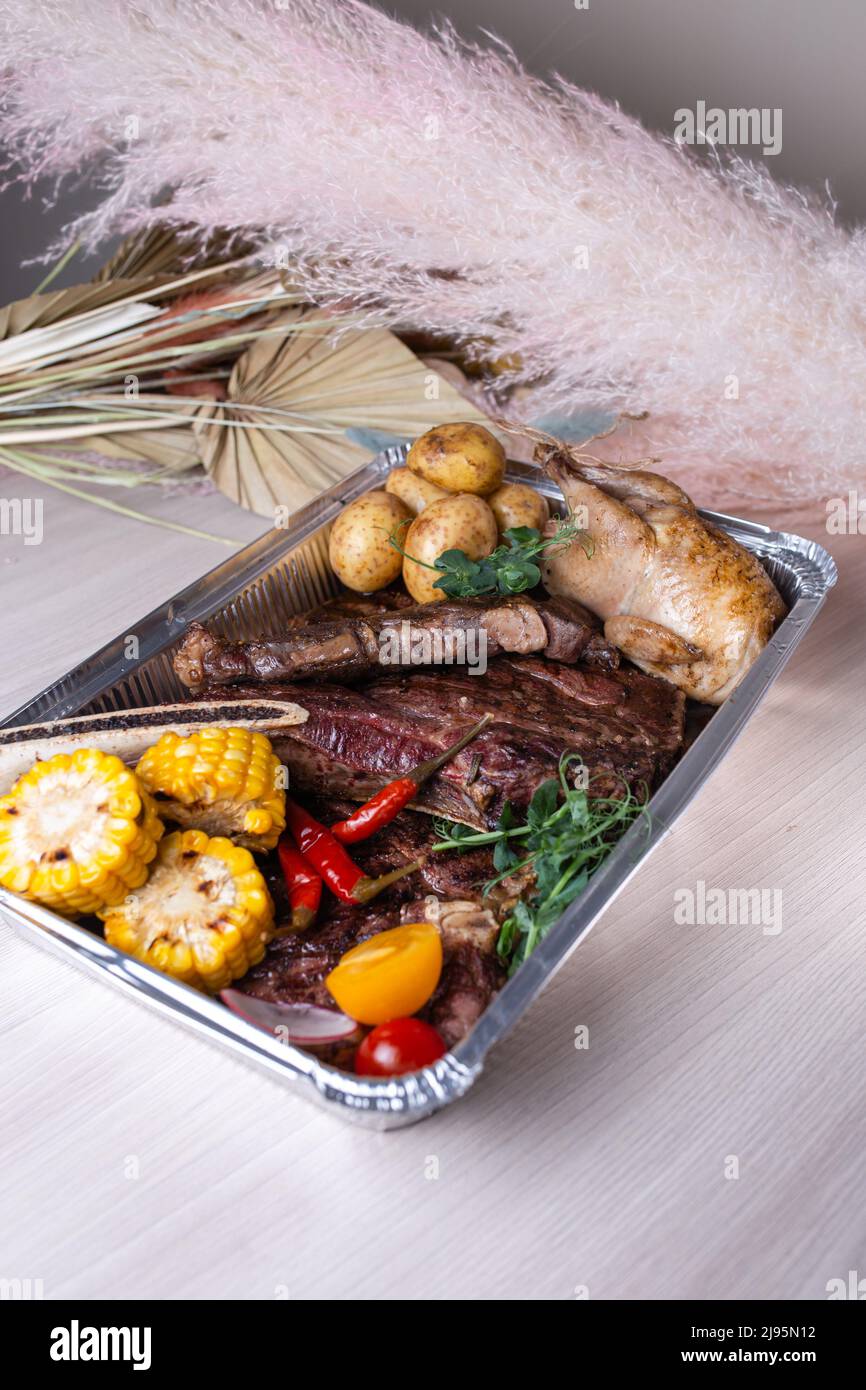 assorted meat dishes. steak, chicken and homemade sausages Stock Photo ...