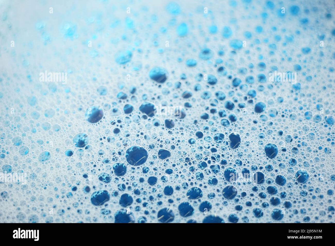 White foam with bubbles popping in blue water Stock Photo - Alamy