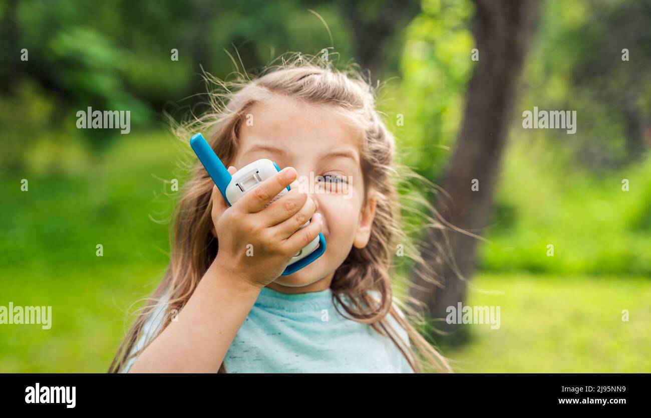 Small girl,kid play in walkie-talkie.Walkie Talkies with channels.Game ...