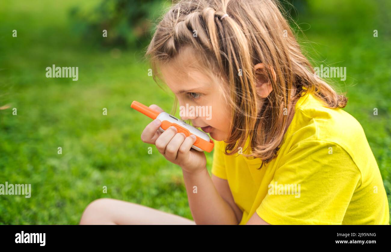 Small girl,kid play in walkie-talkie.Walkie Talkies with channels.Game ...