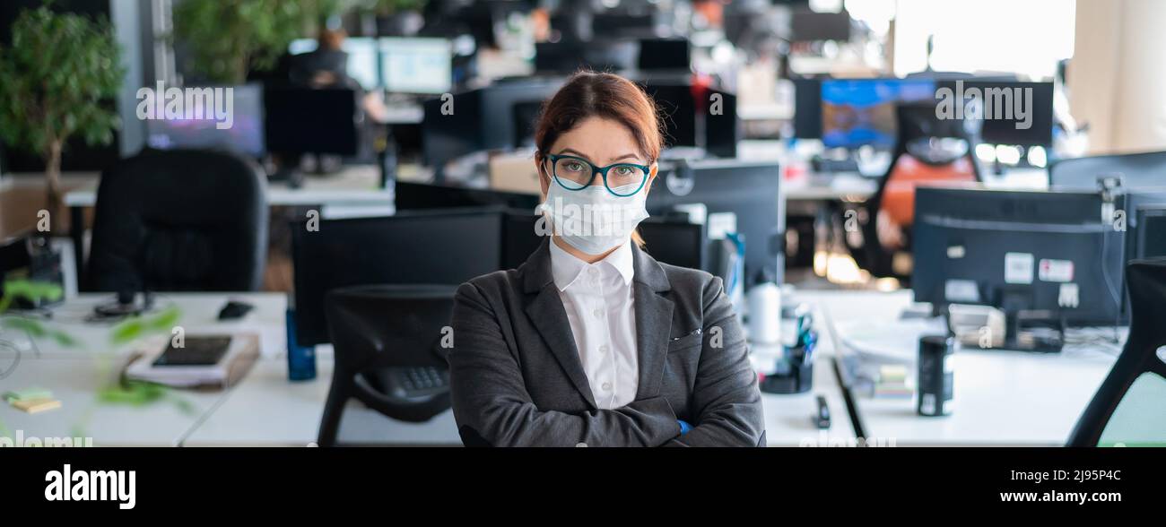 Business woman in office in a protective mask and gloves. Female ...
