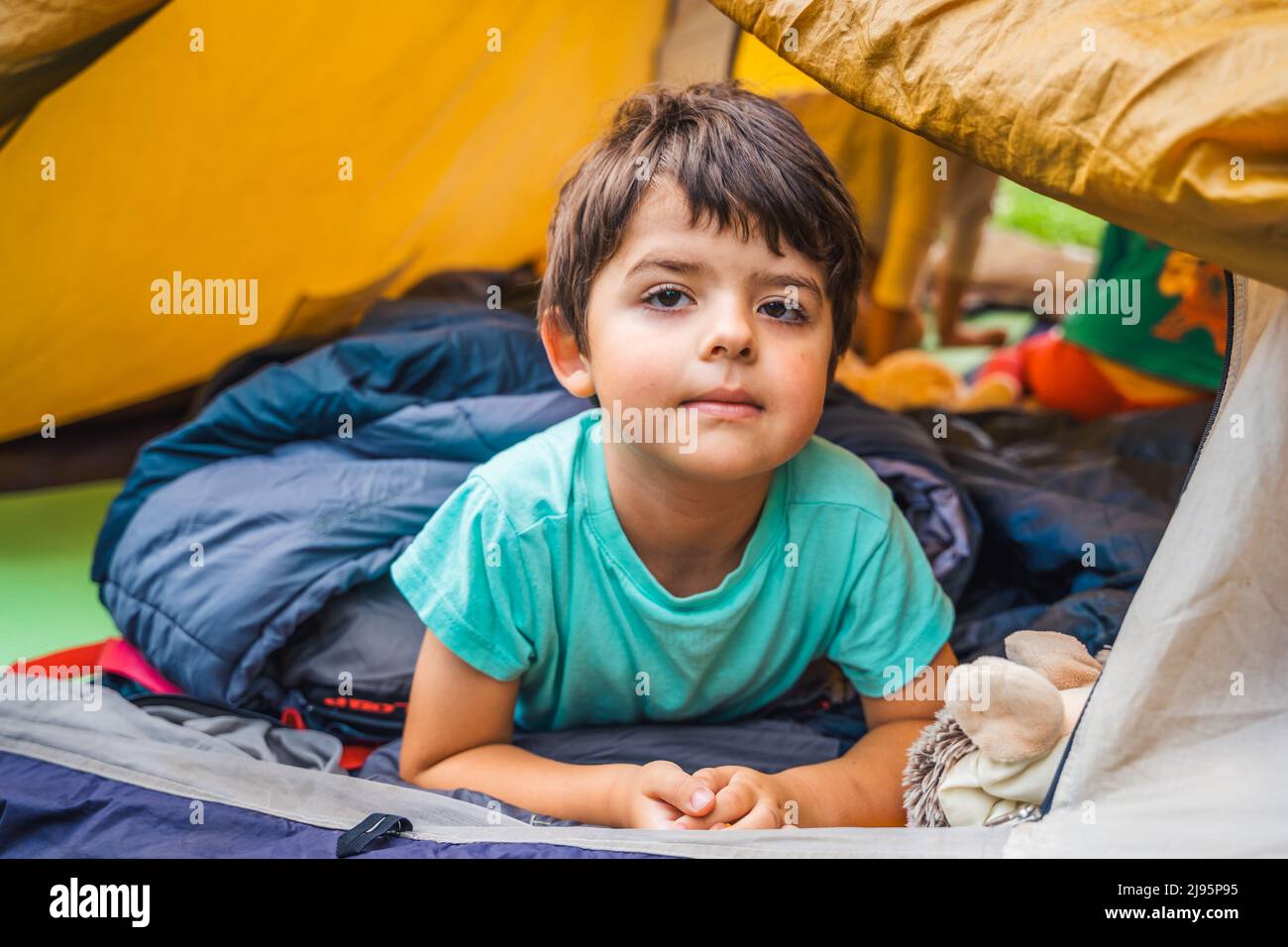 Small children, kids, boy play, sleep in sleepig bag in orange tourist ...