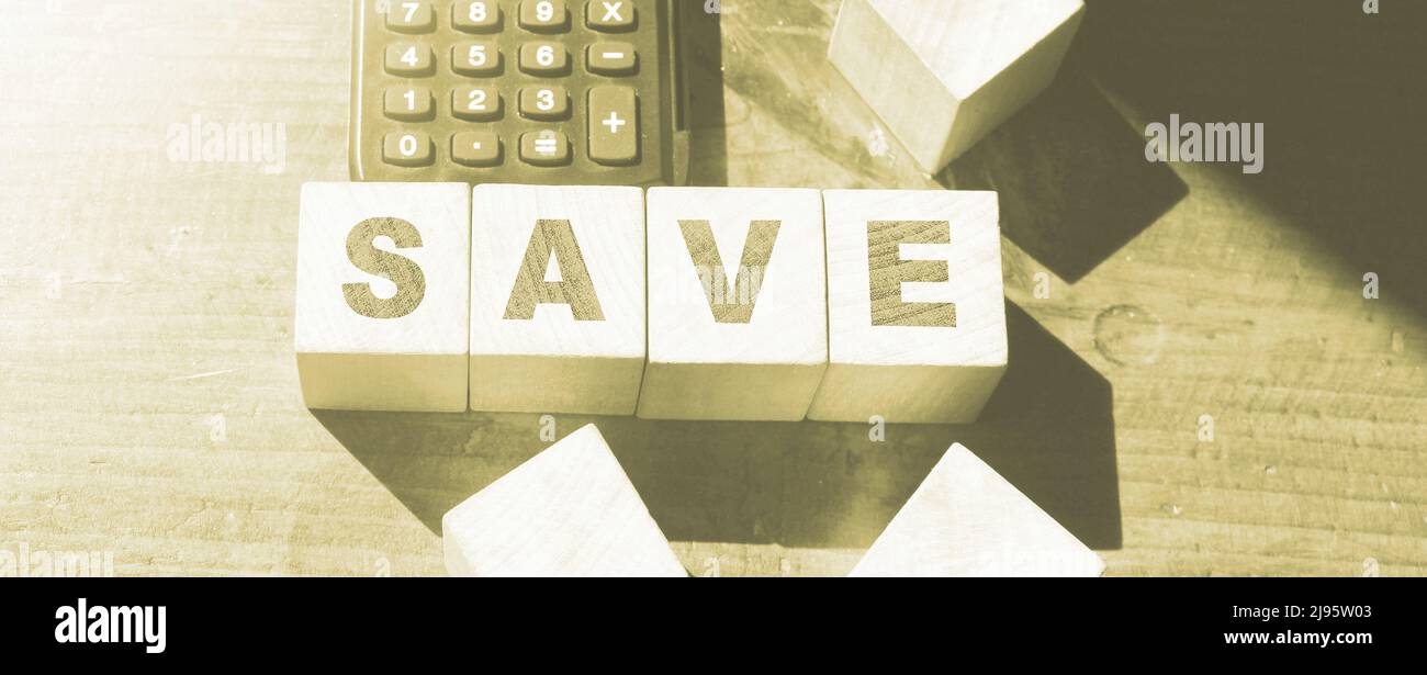 Word Save. Save text on wooden blocks and calculator. Business Concept ...