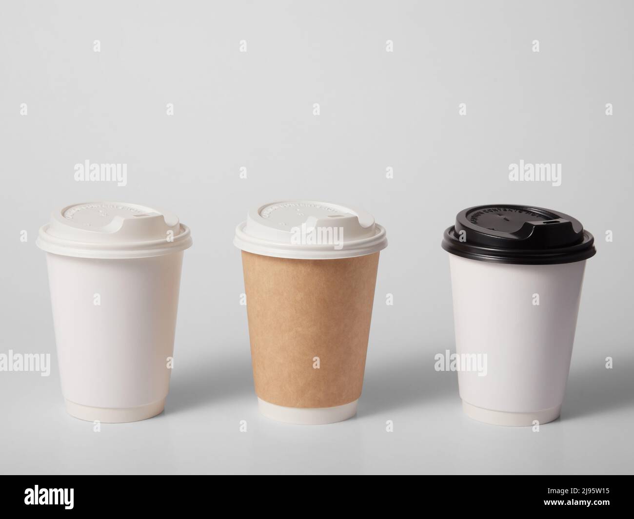 Three takeaway paper cups on white background Stock Photo - Alamy