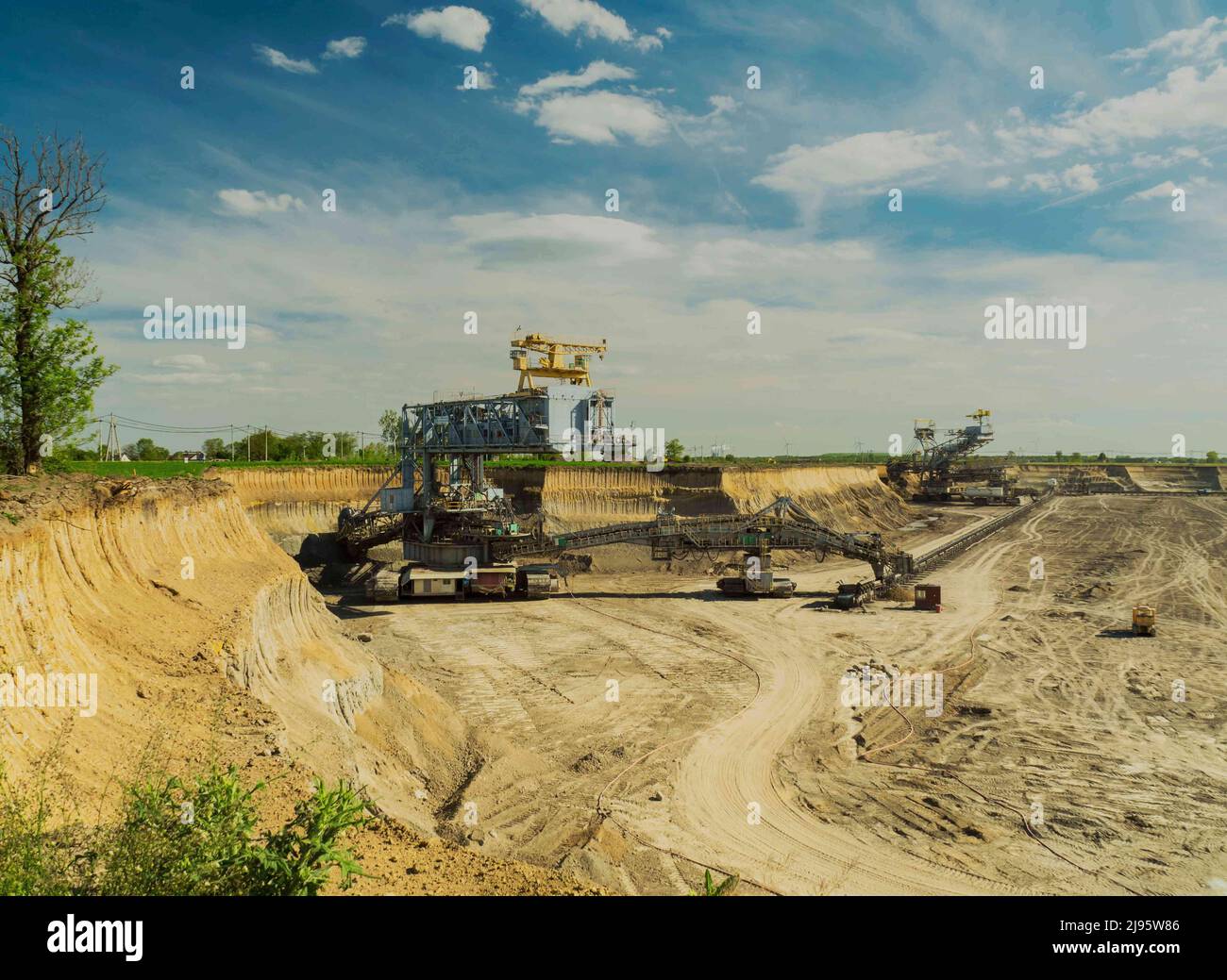 Industrial view of opencast mining quarry with machinery at work. Area ...