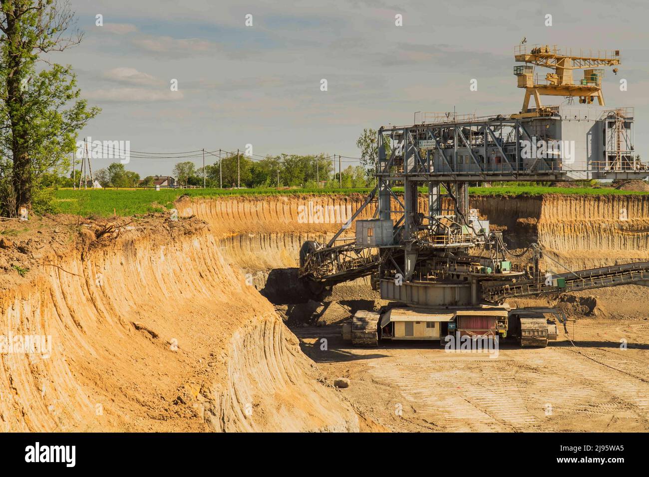Industrial view of opencast mining quarry with machinery at work. Area ...