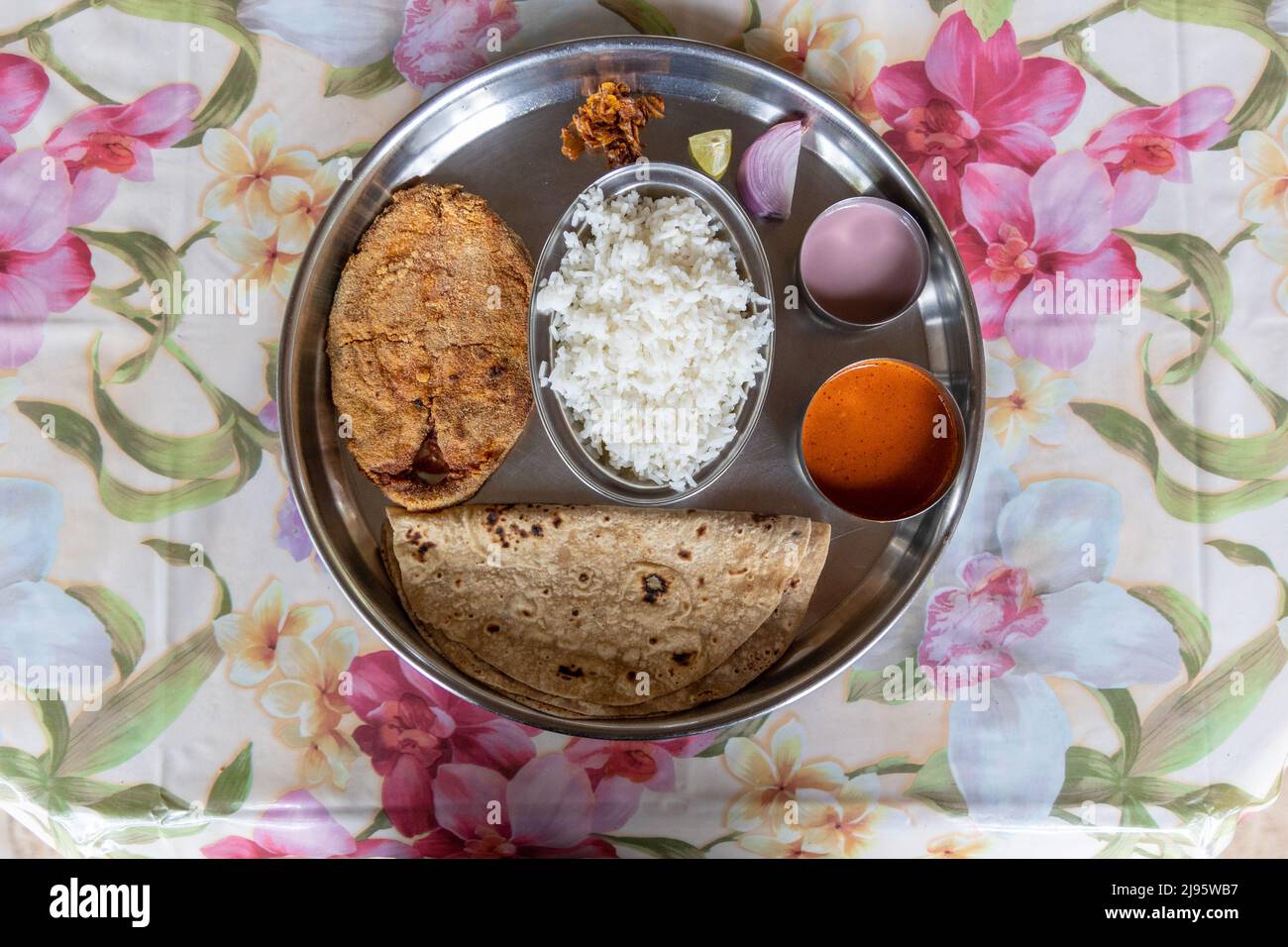 Top view of Malvani kingfish thali consisting of chapati, rice ...