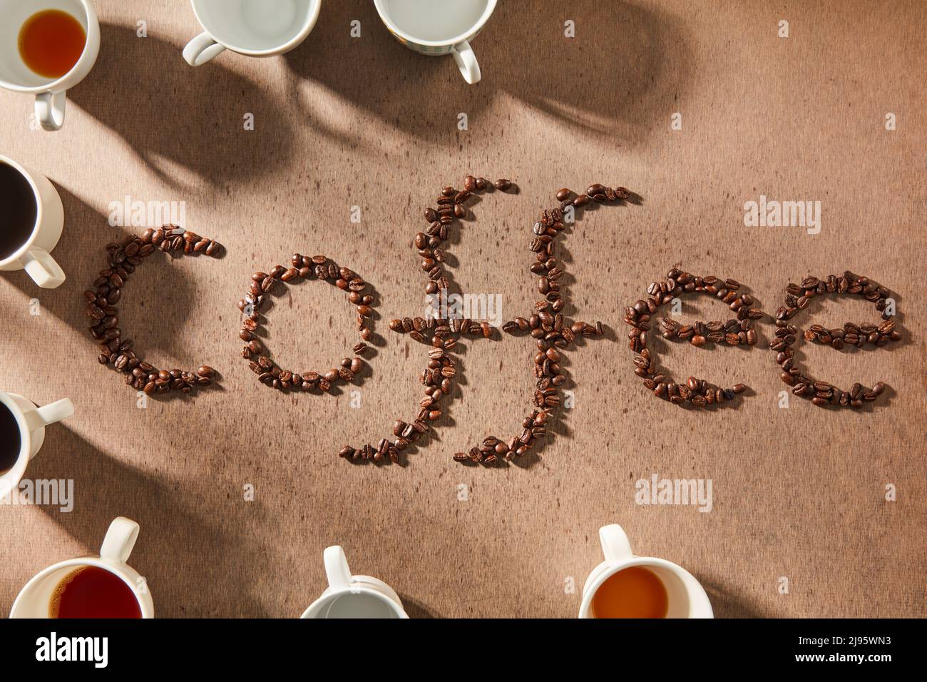 The word 'coffee' made with coffee beans and coffee cups Stock Photo ...