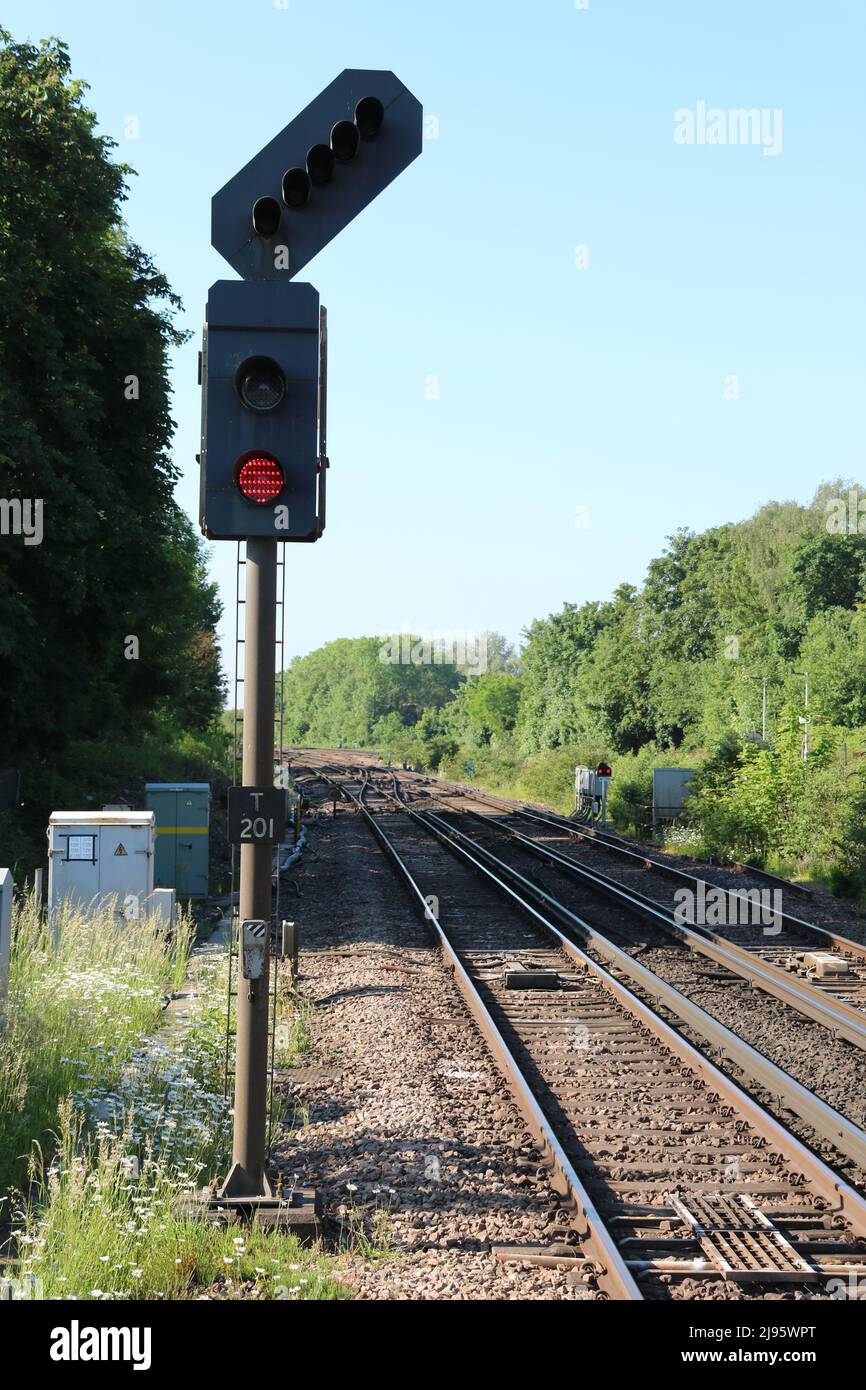 A Modern LED Railway Signal next to a Railway Line with Blue Sky and ...