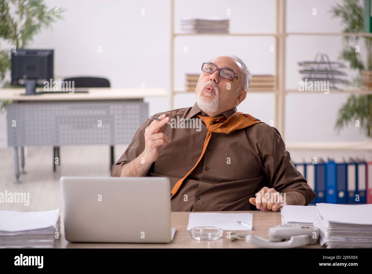 Old businessman employee smoking cigarette at workplace Stock Photo - Alamy