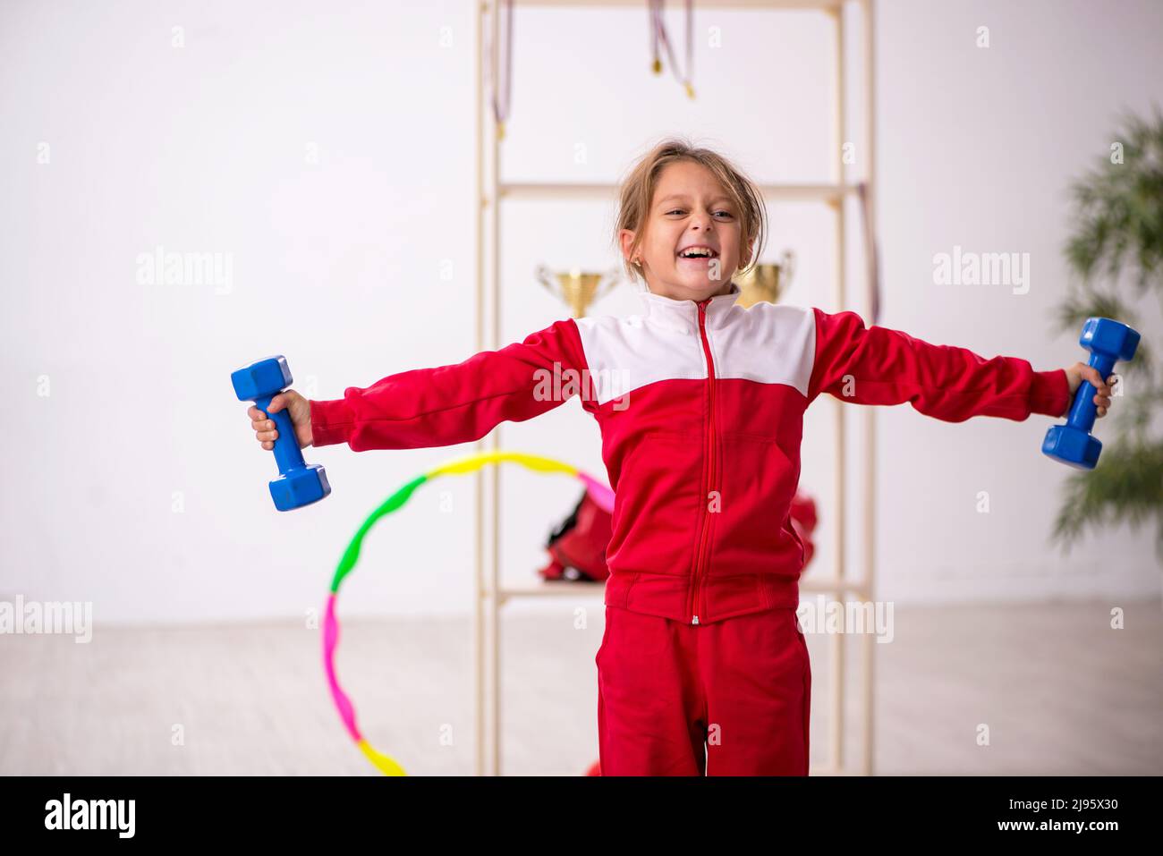 Young small girl doing sport exercises at home Stock Photo - Alamy