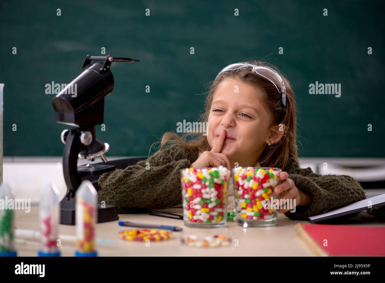Young small girl chemist in the classroom Stock Photo - Alamy