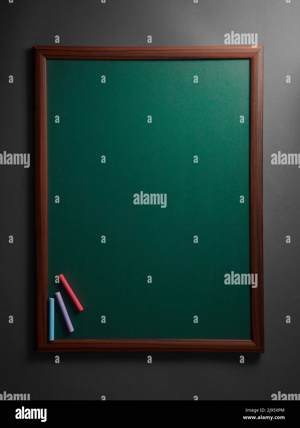 Textured blackboard with chalks, vertical frame Stock Photo - Alamy