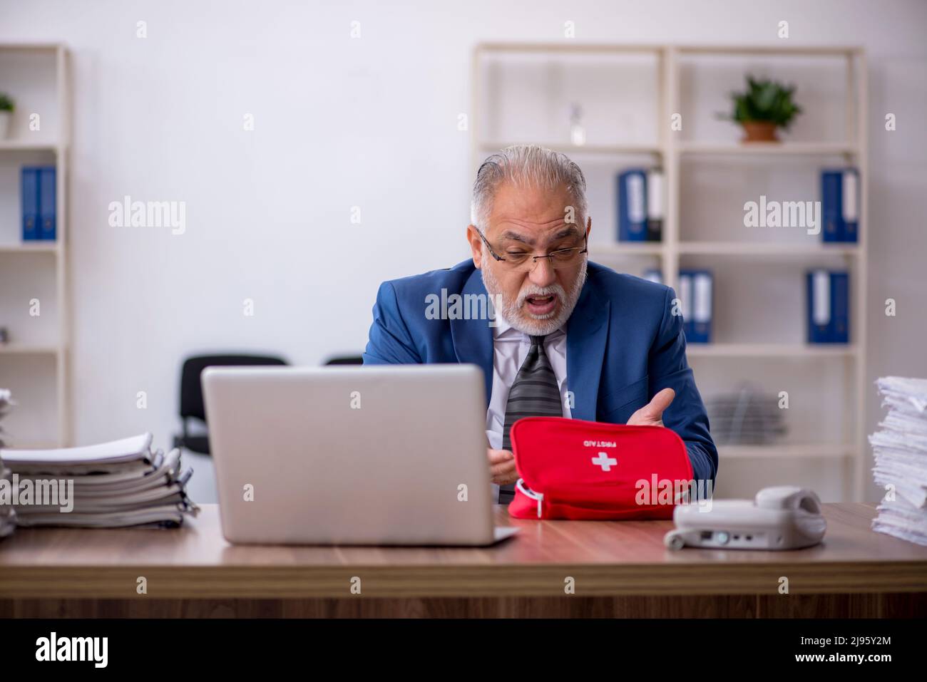 Old businessman employee feeling bad at workplace Stock Photo - Alamy