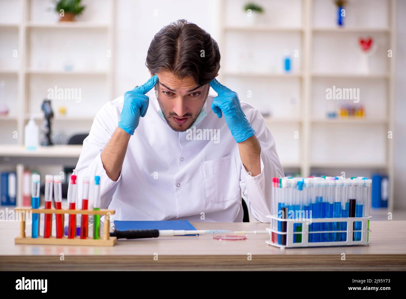 Young chemist working at the lab Stock Photo - Alamy