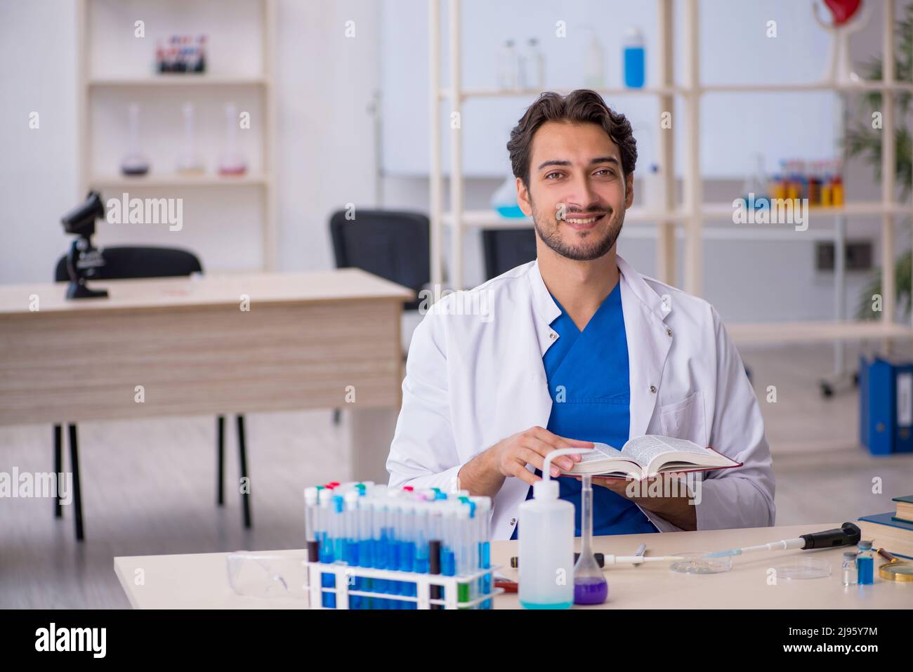 Young chemist working at the lab Stock Photo - Alamy