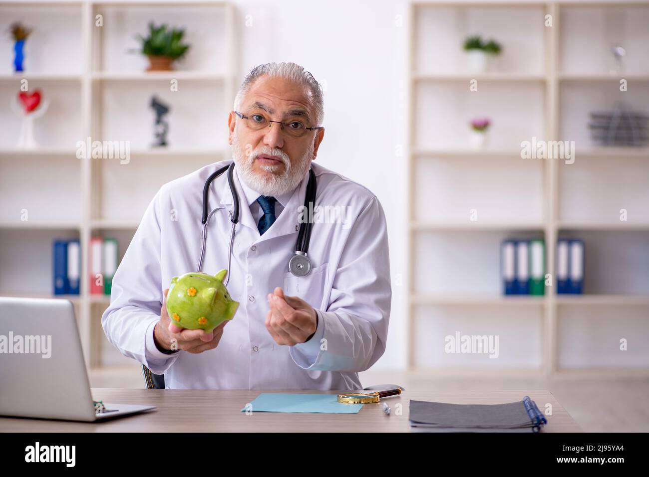 Old doctor in retirement concept Stock Photo - Alamy