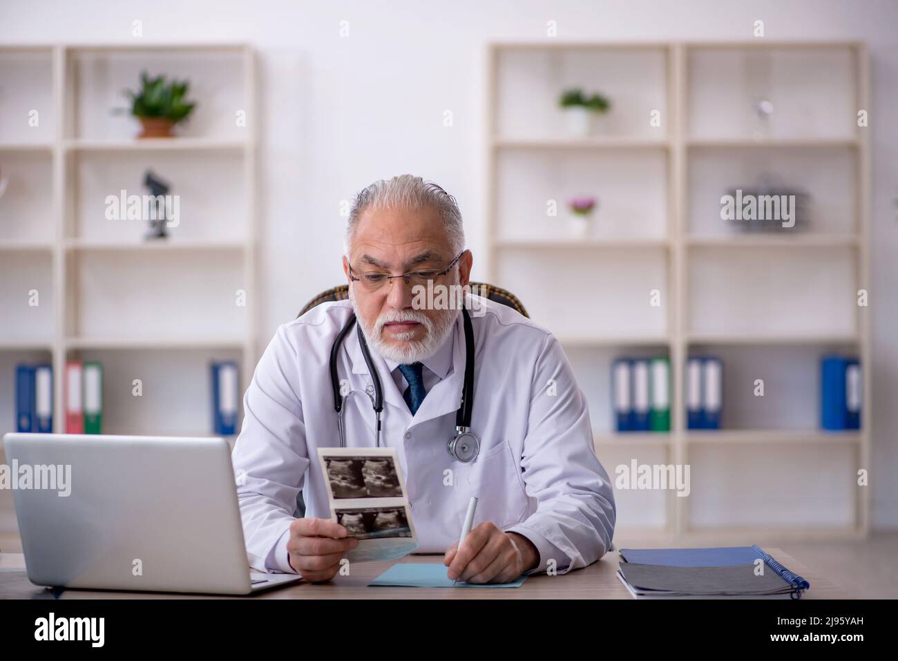 Old doctor radiologist working at the hospital Stock Photo - Alamy