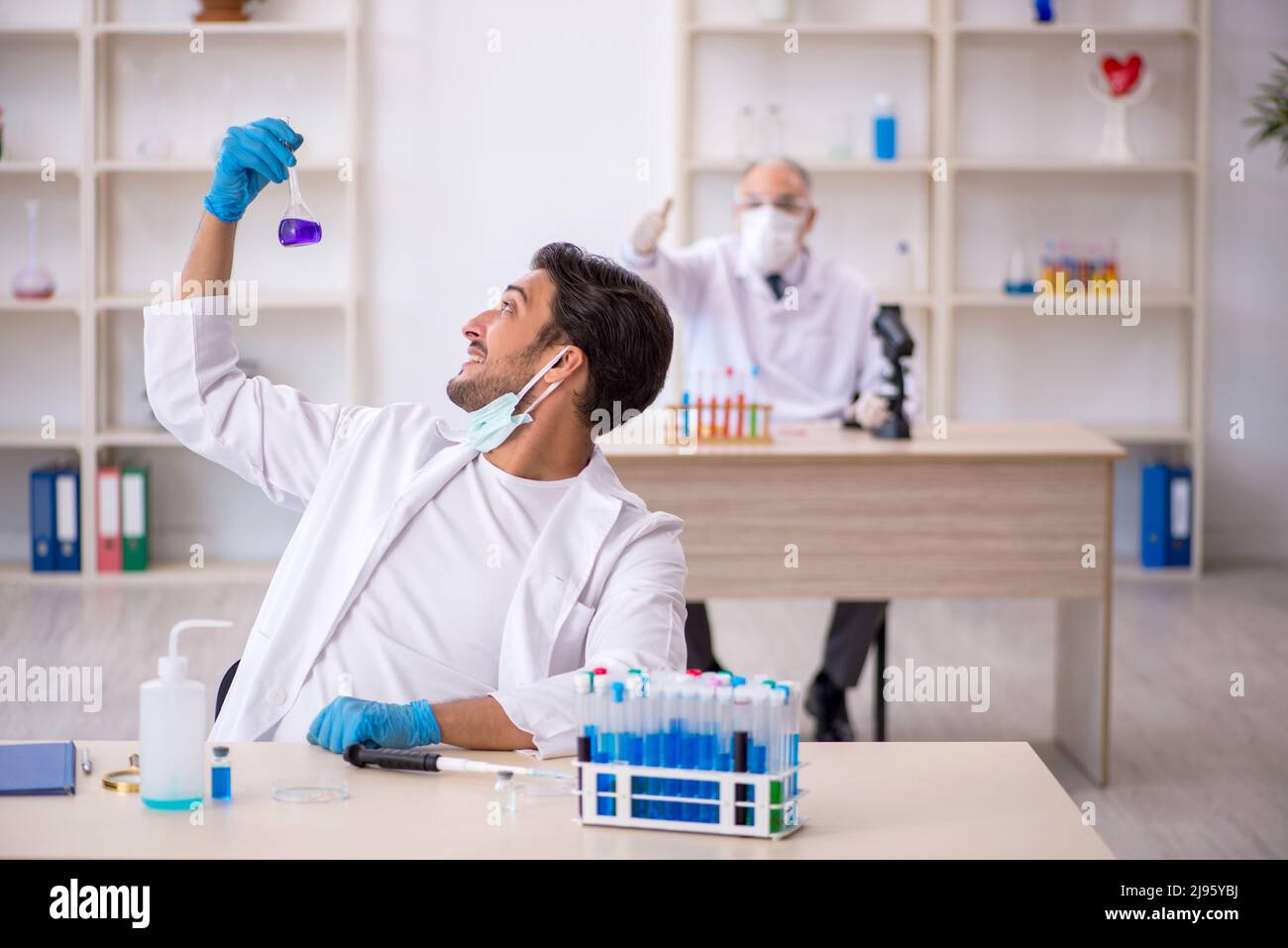 Two chemist working at the lab Stock Photo - Alamy
