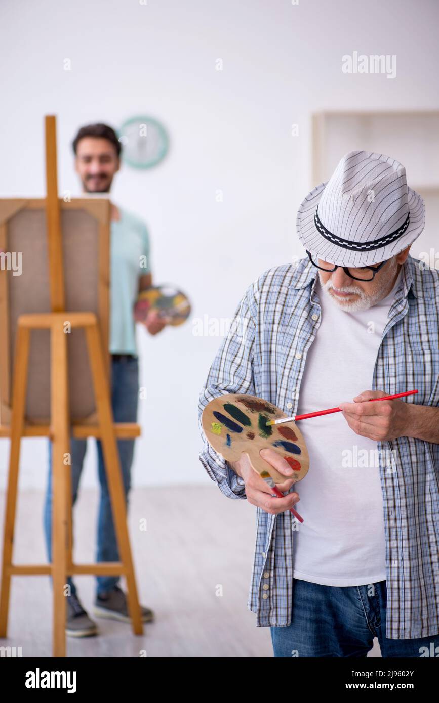 Two painters enjoying painting at home Stock Photo - Alamy